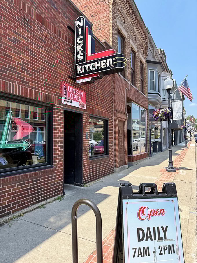 The iconic brick exterior of Nick's Kitchen, with its vintage neon sign promising culinary treasures within. Downtown Huntington's crown jewel beckons hungry travelers.