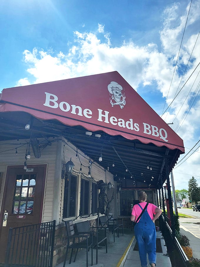 The historic charm of Bone Heads BBQ's exterior, complete with twinkling lights and wraparound porch, promises smoky delights within this Willis landmark.