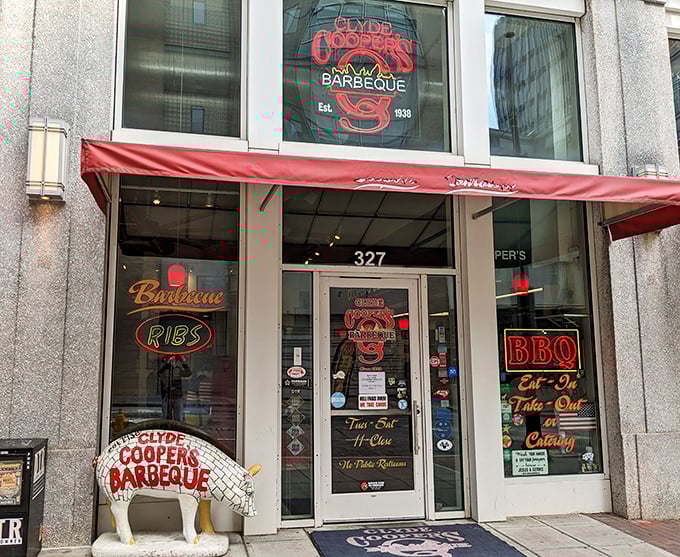 The iconic storefront beckons like a barbecue lighthouse, complete with that whimsical pig statue standing guard. Eastern Carolina's smoky paradise awaits! 