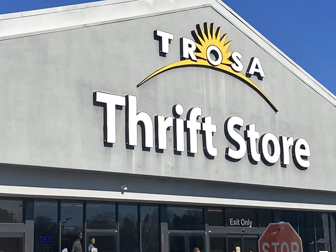 The iconic TROSA Thrift Store sign welcomes bargain hunters with its cheerful sunrise logo – a beacon of hope and hidden treasures in Durham.