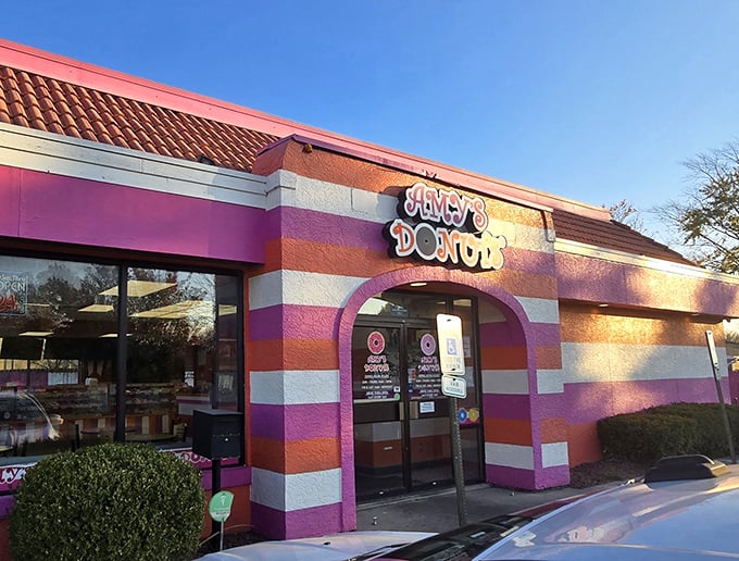 The pink and orange striped exterior of Amy's Donuts isn't just a building—it's a mood-lifting promise of the sugary joy waiting inside.