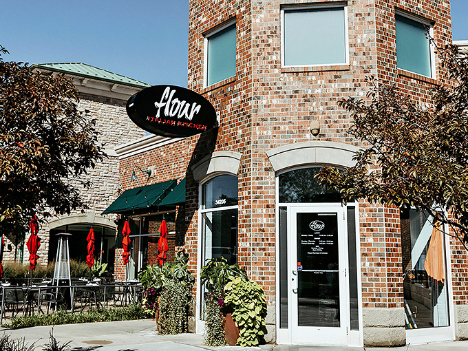 Flour's distinctive brick exterior with its elegant oval sign promises Italian delights within. Those red umbrellas aren't just for show—they're inviting you to linger over aperitivos on warm Ohio evenings.
