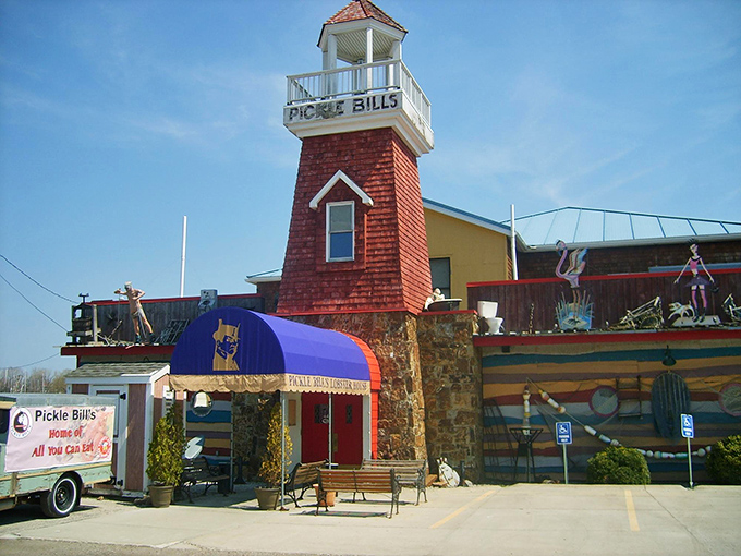 The iconic lighthouse tower of Pickle Bill's stands like a seafood beacon in landlocked Ohio, promising maritime delights just beyond those blue awnings.