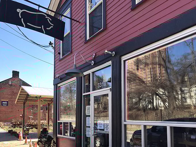 The unassuming red exterior of Eli's BBQ, with its simple pig silhouette sign, is like a secret handshake for barbecue aficionados in Cincinnati.