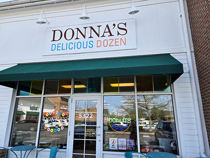 The unassuming storefront of Donna's Delicious Dozens beckons with its cheerful turquoise chairs and simple signage—proof that donut paradise often hides in plain sight.