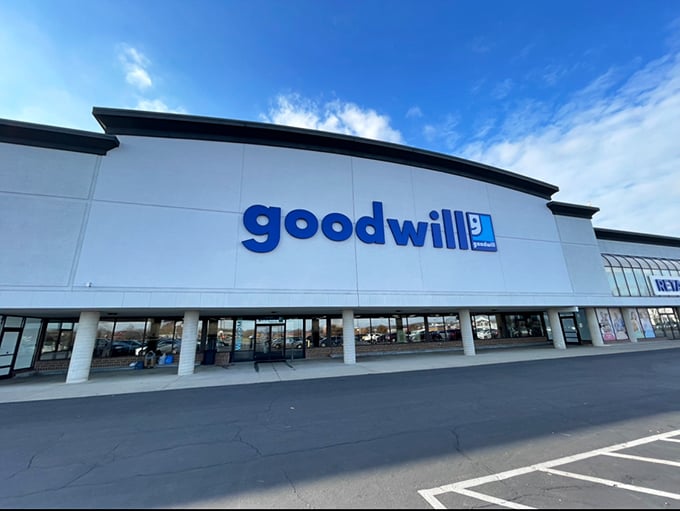 The iconic blue Goodwill sign beckons bargain hunters like a retail lighthouse, promising treasures within that won't require a second mortgage.