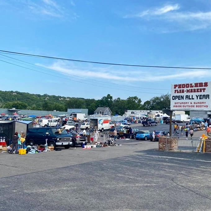 The sprawling landscape of Peddlers Flea Market under Cincinnati's blue sky – where one person's castoffs become another's treasures every weekend.