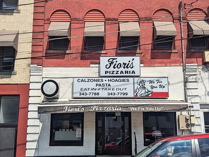 The classic red brick façade of Fiori's Pizzaria stands as a beacon of hope for the pizza-deprived. "We Fix You Up" isn't just a motto—it's a promise.