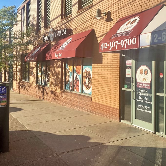 The unassuming brick exterior with bold red awnings is like a secret handshake – those who know, know this is where Pittsburgh's soul food magic happens.