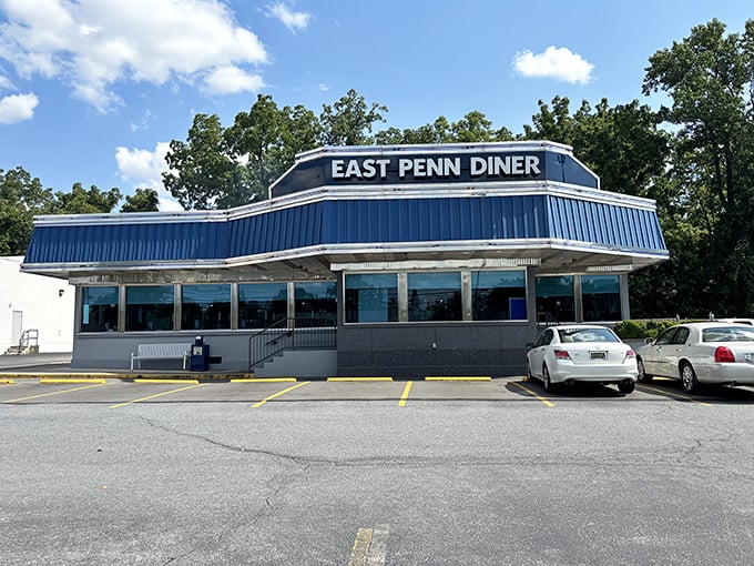 Morning sunshine bounces off the classic blue-and-white facade, while a full parking lot tells the story better than any review ever could.