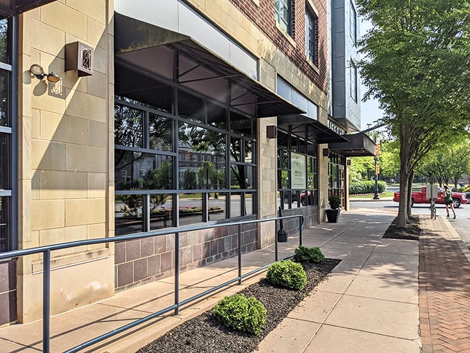 The modern façade of Iron Hill beckons with its inviting patio, promising craft beer nirvana and burger bliss just steps from Lancaster's bustling streets.