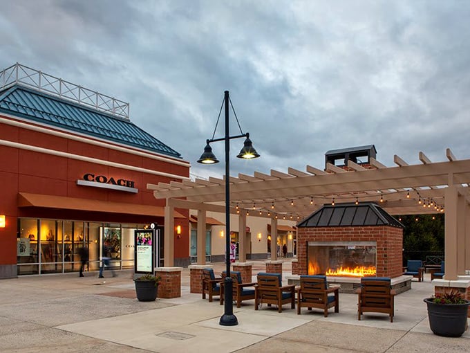 The Coach store stands proudly beside a cozy outdoor lounge area where a fireplace beckons weary shoppers to rest their bargain-laden arms.