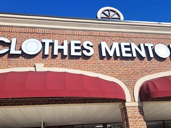 The brick facade and bold red awnings of Clothes Mentor aren't just eye-catching—they're practically waving you in like a fashion-forward friend with insider deals.