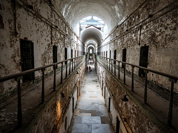 Cell Block 7 stretches into infinity like a dystopian cathedral. The peeling paint and crumbling walls tell stories that no prison documentary could ever capture.
