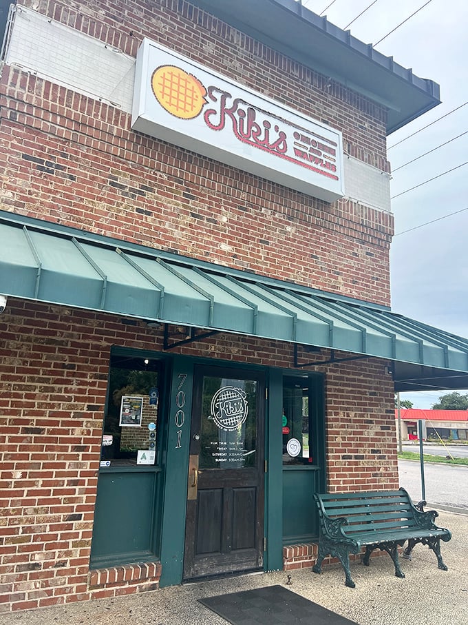 The brick fortress of flavor that houses Kiki's Chicken and Waffles stands unassumingly on Parklane Road, its green awning beckoning hungry travelers like a culinary lighthouse.