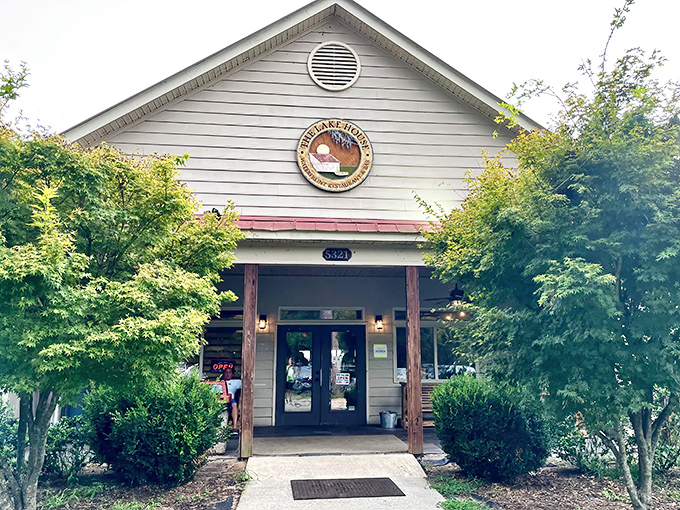 The Lake House welcomes you with understated charm, its weathered wooden sign and lush greenery promising culinary adventures that await inside.
