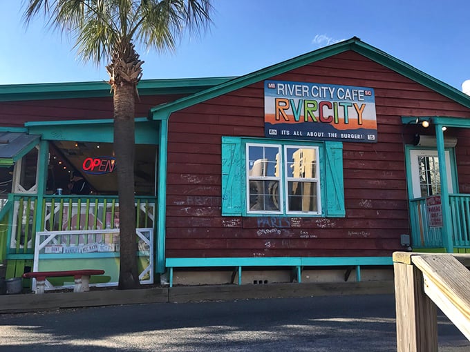 The weathered burgundy siding and turquoise trim scream "beach shack with attitude." This isn't where you go to impress a first date—it's where you take someone you actually like.