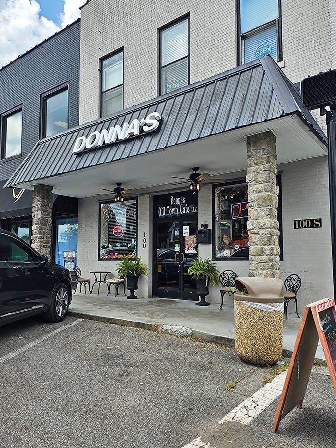 The welcoming facade of Donna's Old Town Cafe beckons hungry travelers with its charming stone columns and metal awning—small-town Tennessee hospitality in architectural form.