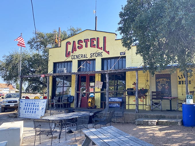 The bright yellow facade of Castell General Store stands like a beacon of hope for hungry travelers, promising authentic Texas charm and satisfying meals ahead.