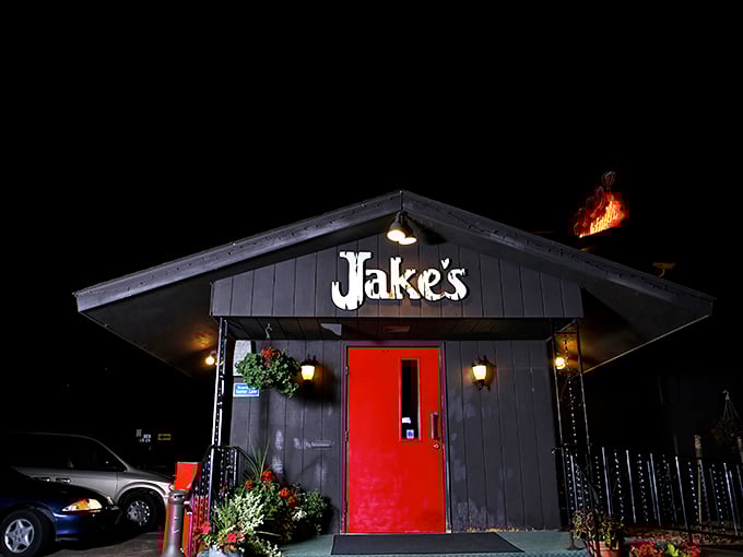 That iconic red door against the dark exterior isn't just an entrance—it's a portal to prime rib paradise that's been beckoning hungry Wisconsinites for generations.