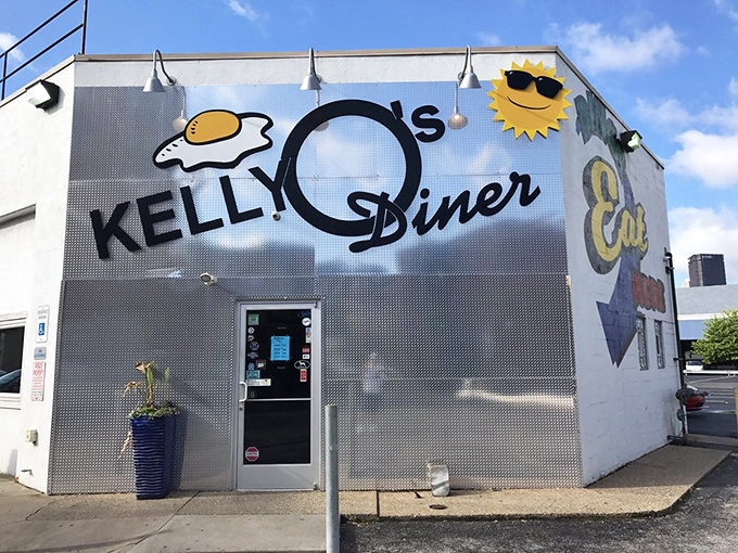The iconic silver exterior of Kelly O's Diner gleams in the Pittsburgh sun, its egg-and-sun logo promising breakfast bliss ahead.