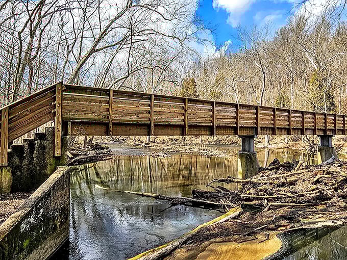 The wooden bridge spanning the Little Miami River offers more than just passage – it's a front-row seat to nature's quiet symphony of flowing water and rustling leaves.