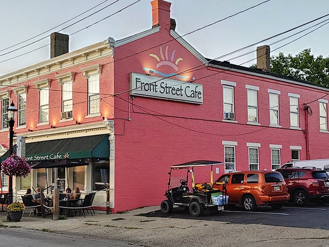 The historic red brick façade of Front Street Café glows at dusk, beckoning hungry travelers with the promise of culinary treasures within.