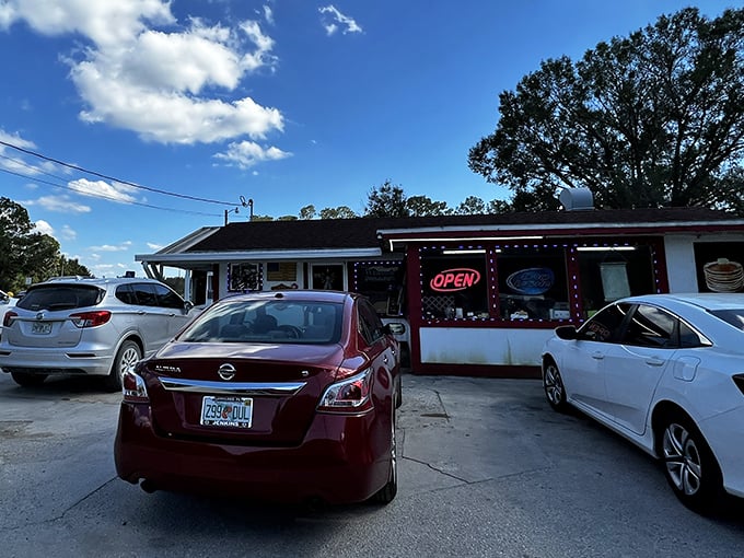 The unassuming exterior of Red Top Pit Stop beckons with its neon "OPEN" sign—a humble invitation to one of Florida's most delicious BBQ experiences.