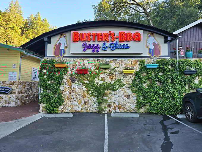 Stone walls draped with ivy frame the bold red "BUSTER'S BBQ" sign – a siren call to barbecue pilgrims in wine country's unexpected smoke sanctuary.