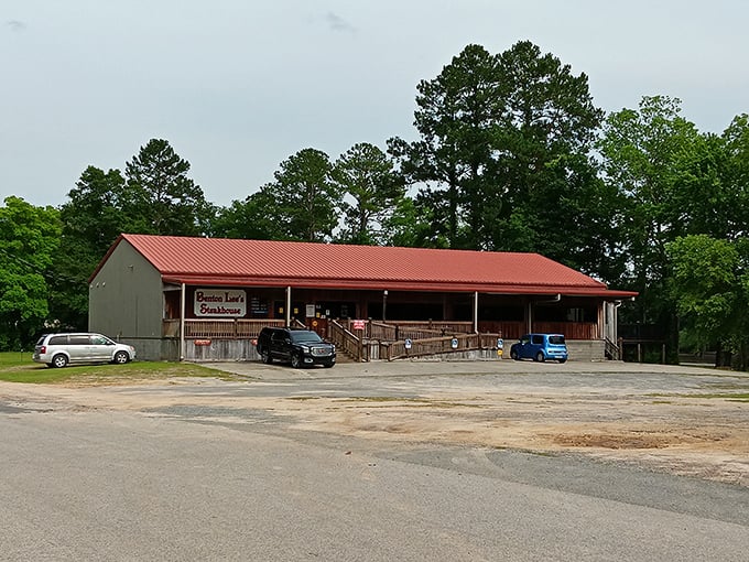 A wider view reveals Benton Lee's rustic charm nestled among Georgia pines – where pickup trucks in the parking lot tell the real story.