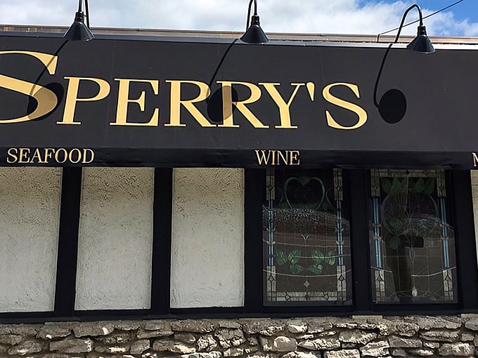 That awning isn't just for show – it's the gateway to prime rib paradise, where stained glass windows hint at the treasures waiting inside.