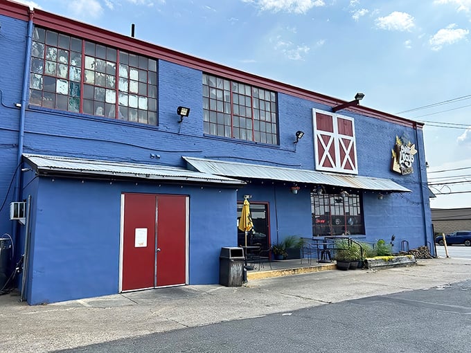 That blue barn exterior isn't fooling anyone – this is where serious barbecue magic happens daily.