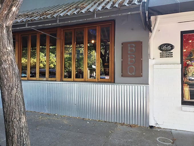 The unassuming exterior of KINSmoke hides barbecue greatness like a poker player with four aces – that corrugated metal siding is your first clue something special awaits.