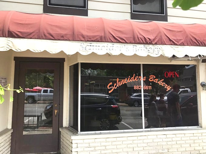 That neon sign might as well say "PARADISE" instead of "OPEN" – Schneider's storefront has been guiding hungry pilgrims to donut nirvana for generations.