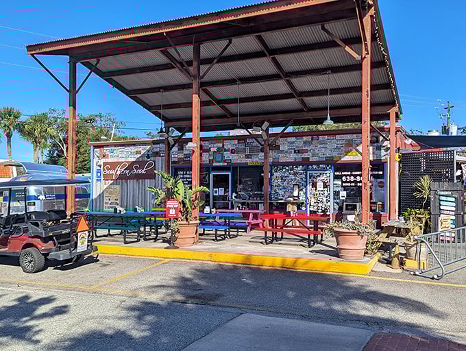 The converted gas station exterior says everything you need to know: unpretentious, welcoming, and promising smoky delights under that metal roof.