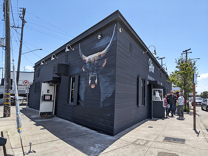 The striking longhorn mural on Horn Barbecue's exterior isn't just decoration—it's a promise of the primal, smoky delights waiting inside this Oakland treasure.