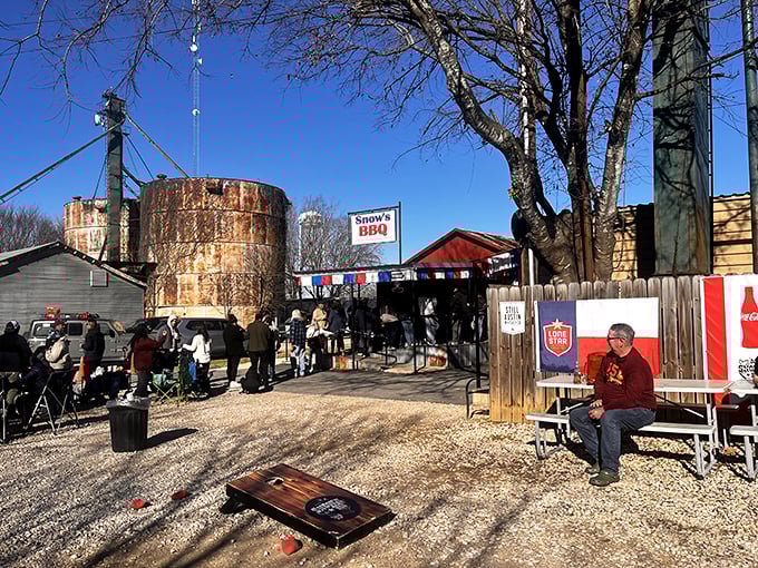 The pilgrimage begins here – a humble gravel lot under Texas skies where barbecue dreams come true and morning shadows stretch like hungry customers.