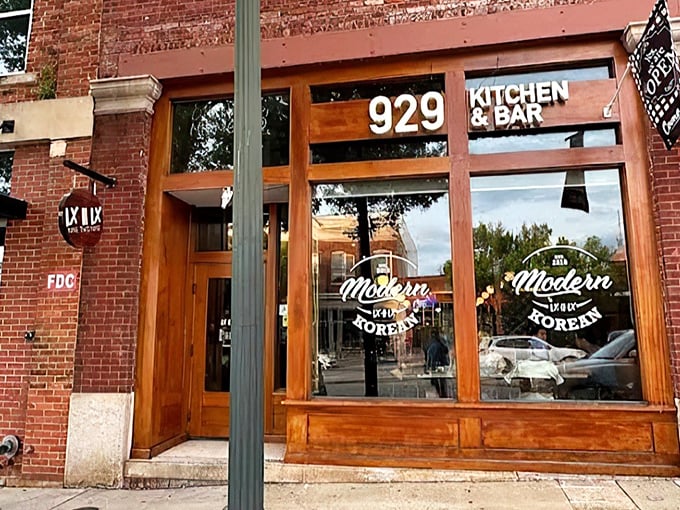 The unassuming storefront of 929 Kitchen & Bar beckons with warm wooden accents and a promise of modern Korean flavors waiting inside.
