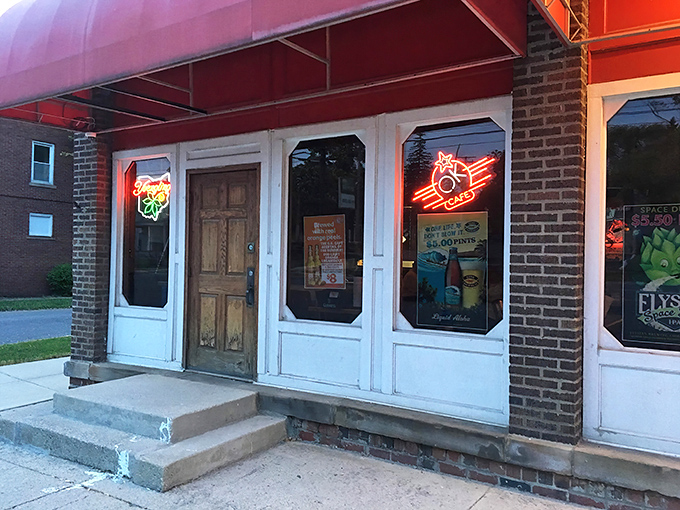 The iconic red awning of OK Cafe stands out against the historic brick building, beckoning hungry travelers like a pizza lighthouse on East Center Street.