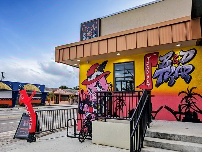 The cartoon pig in a red hat isn't just cute – it's a beacon of barbecue brilliance. B&D Trap's vibrant exterior promises flavor adventures that the bland beige buildings around it can only dream about.