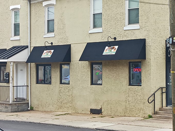 The unassuming yellow brick exterior of Dino's Pizza & Steaks stands like a culinary lighthouse in Bridgeport, beckoning hungry travelers from miles around.