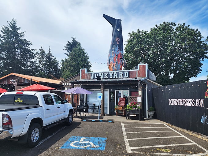 The airplane tail fin jutting from the roof isn't just decoration – it's your first clue that Junkyard's burgers will send your taste buds soaring.