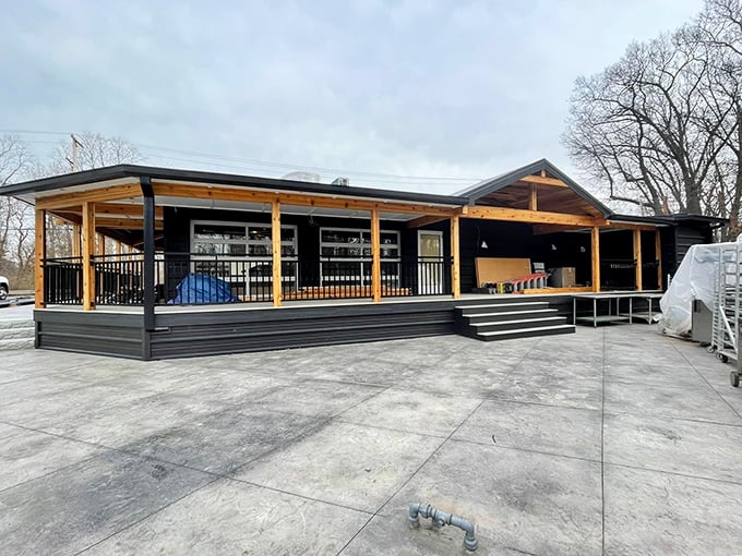 The modern rustic exterior of Magnolia & Pine beckons with its warm wooden accents and spacious porch—architectural proof that great food deserves a worthy stage.