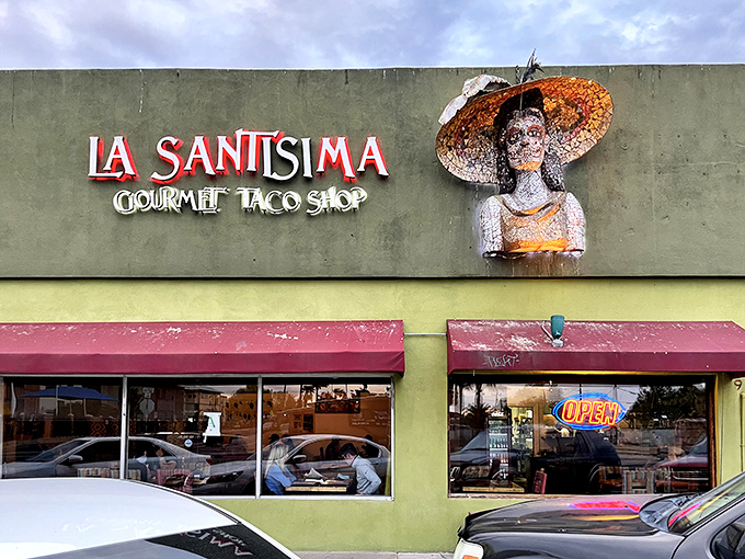 The iconic façade of La Santisima stands out with its vibrant yellow and red trim, like a delicious postcard from Mexico that somehow landed in Phoenix.