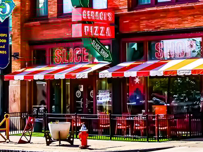 The neon beacon of Geraci's Slice Shop glows like a pizza lighthouse on Cleveland's bustling street, promising salvation for the hungry downtown wanderer.