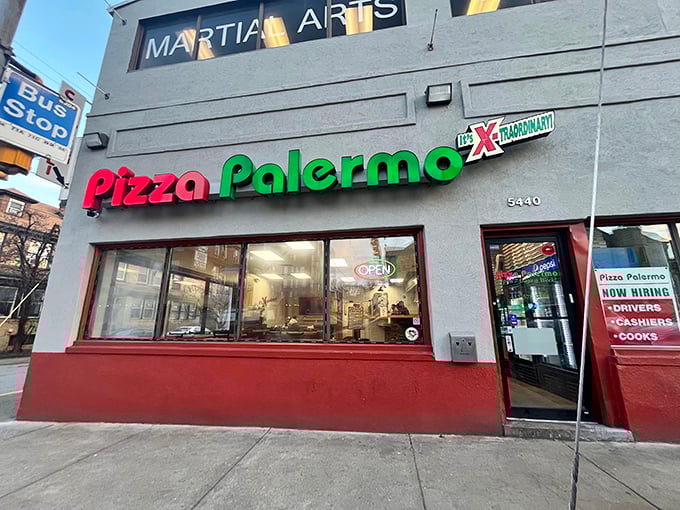 The unassuming storefront of Pizza Palermo, where culinary magic hides behind modest red and green signage. Pittsburgh's best-kept pizza secret sits quietly on Centre Avenue.