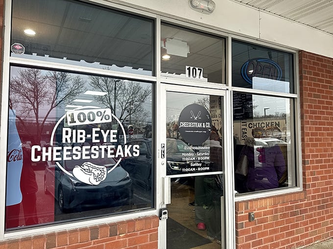 The unassuming storefront boldly proclaims "100% RIB-EYE CHEESESTEAKS" – a siren call to sandwich lovers hiding in plain sight at Rowanberry Center.