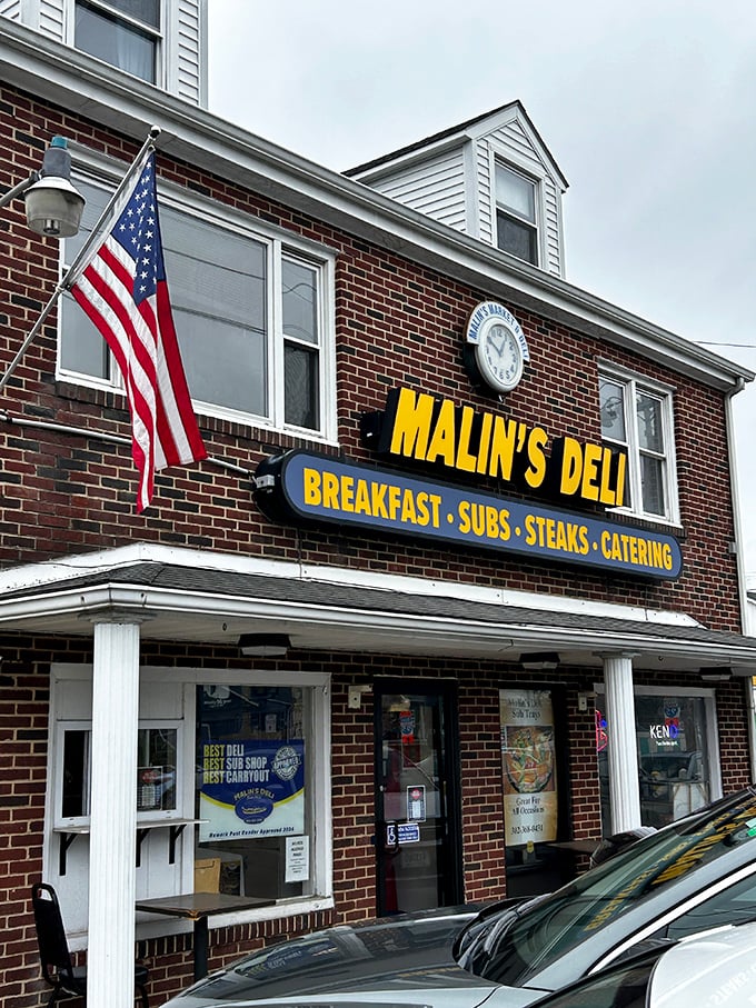 The classic brick facade and bold yellow sign promise no frills, just thrills for your taste buds.