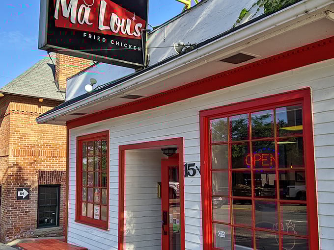 The white clapboard building with bold red trim isn't just eye-catching—it's a beacon for fried chicken pilgrims seeking salvation in crispy, juicy form.