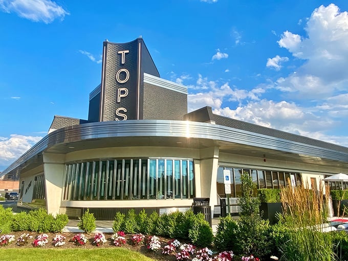 The sleek, modern exterior of Tops Diner stands like a culinary lighthouse in East Newark, beckoning hungry travelers with its iconic signage and promise of extraordinary comfort food.